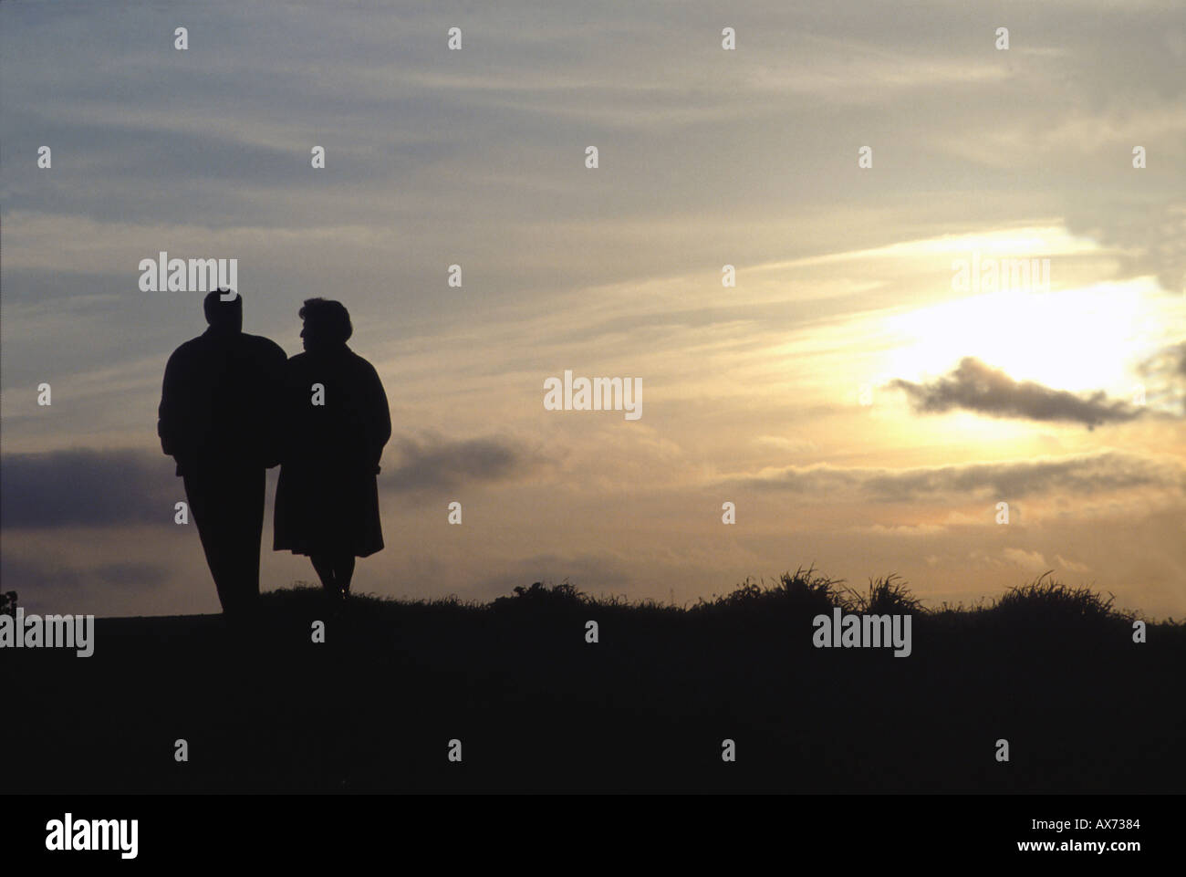 couple walking in the country at sunset Stock Photo - Alamy