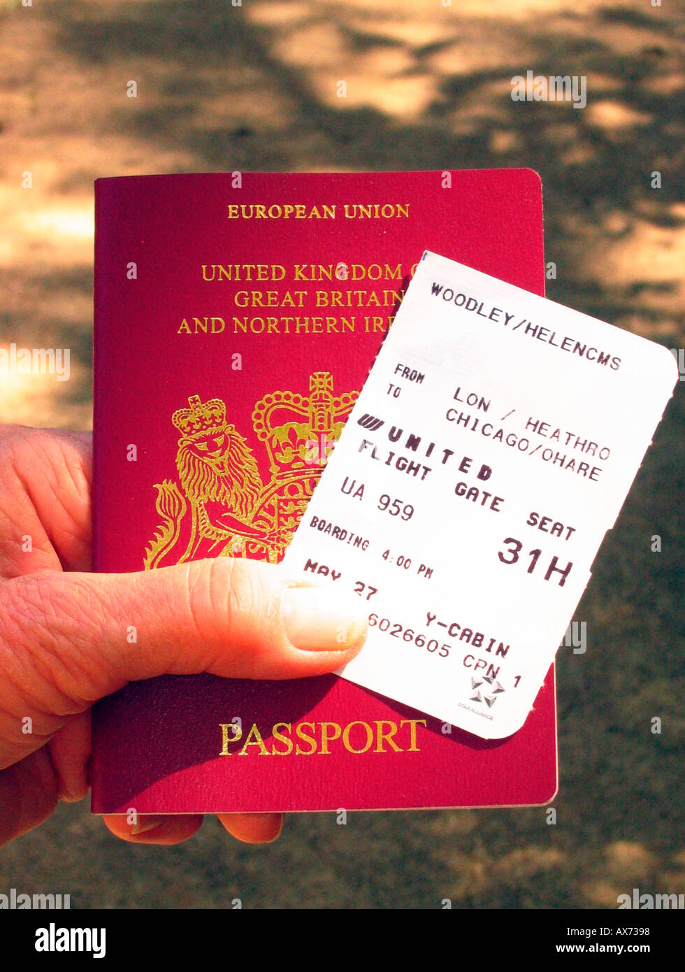Woman holds United Kingdom passport and airline boarding pass stub ...