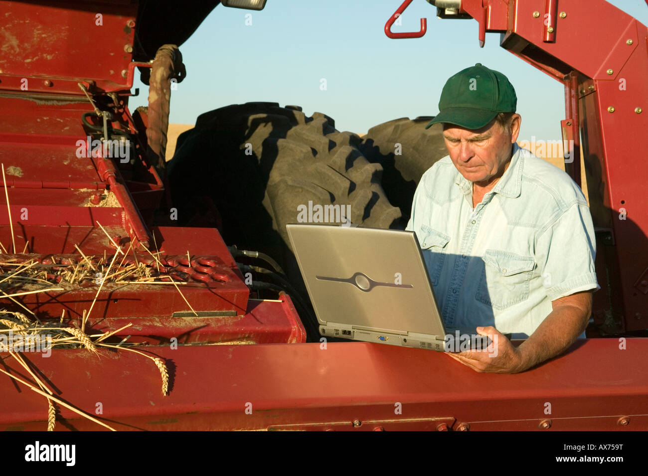 Farmer working on laptop computer Stock Photo - Alamy