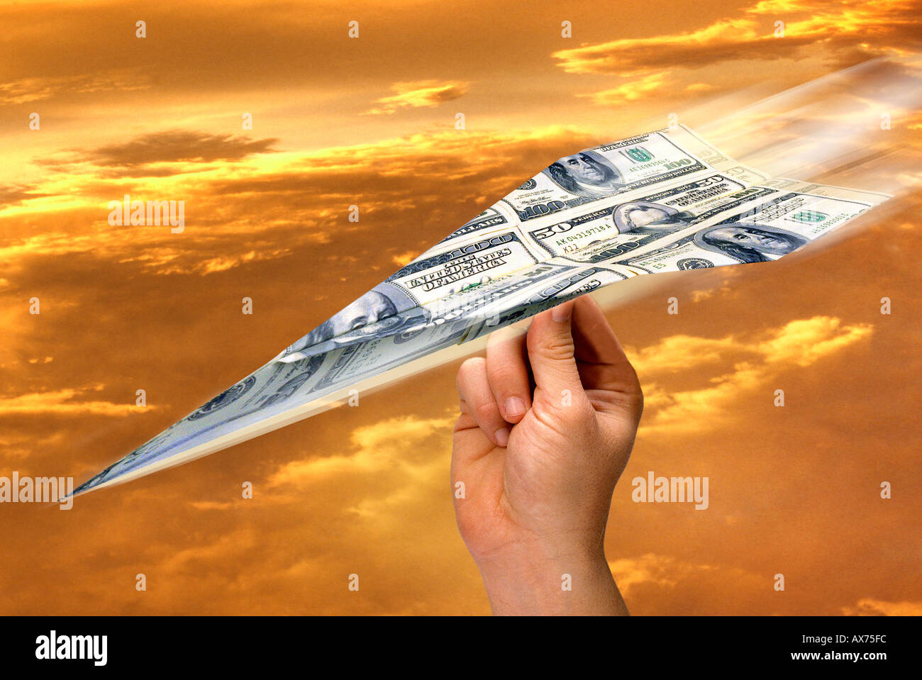 Hand holding colorful paper airplane made from money Stock Photo - Alamy