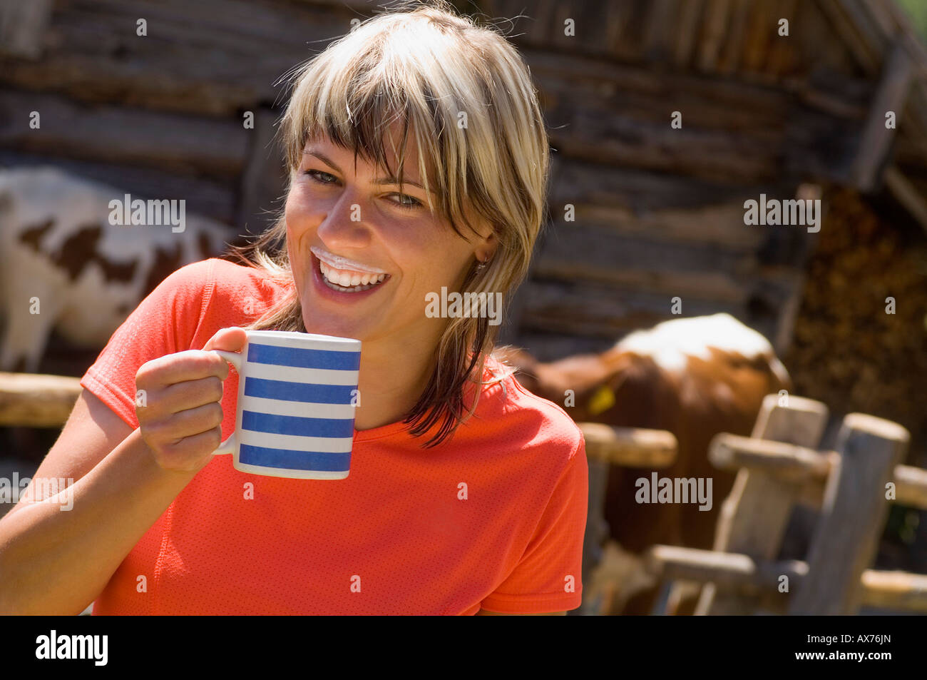 Austria, Salzburger Land, Young woman drinking a cup of milk Stock ...