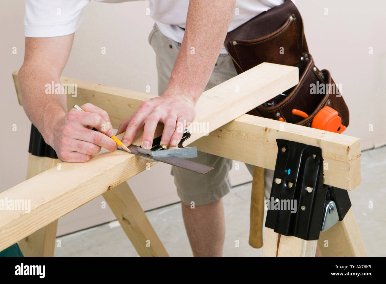 Mid section view of a man marking with a level on a plank Stock Photo ...
