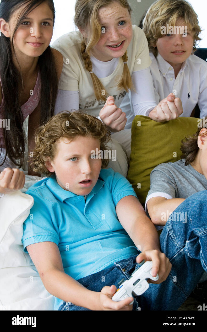 High angle view of a boy playing a video game with his friends Stock ...