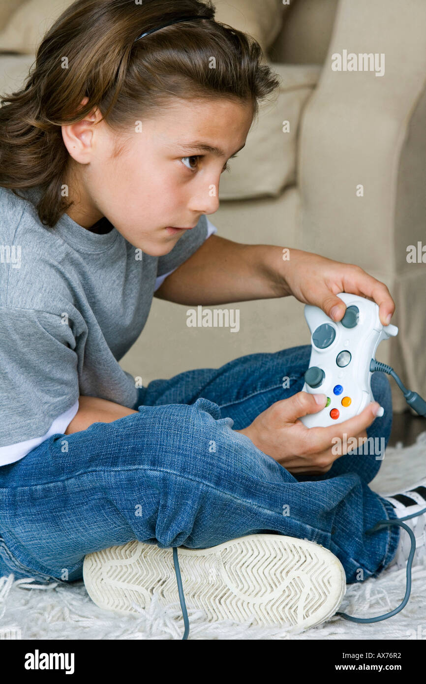 Side profile of a boy playing a video game Stock Photo - Alamy