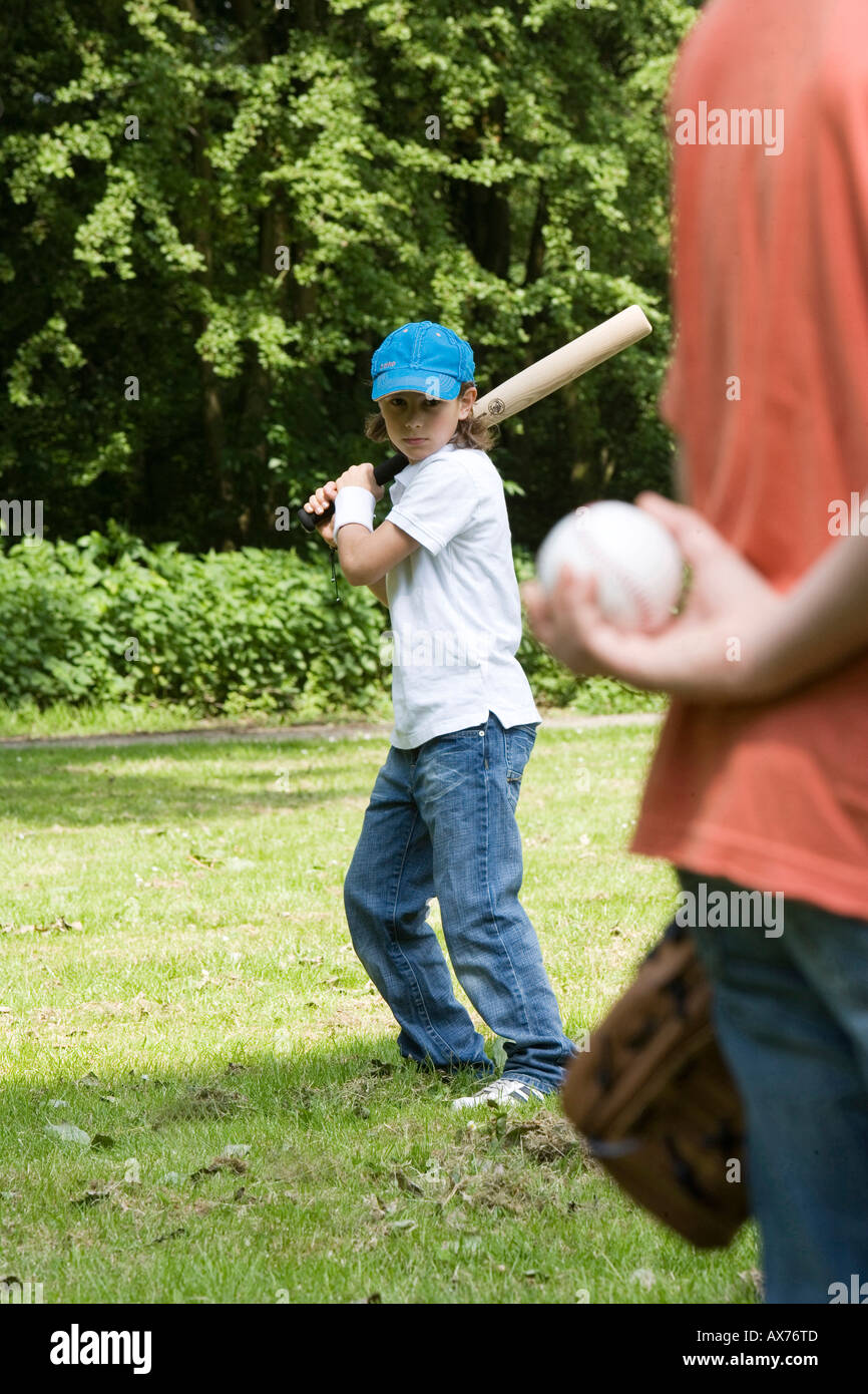 Two children playing baseball in a park Stock Photo - Alamy