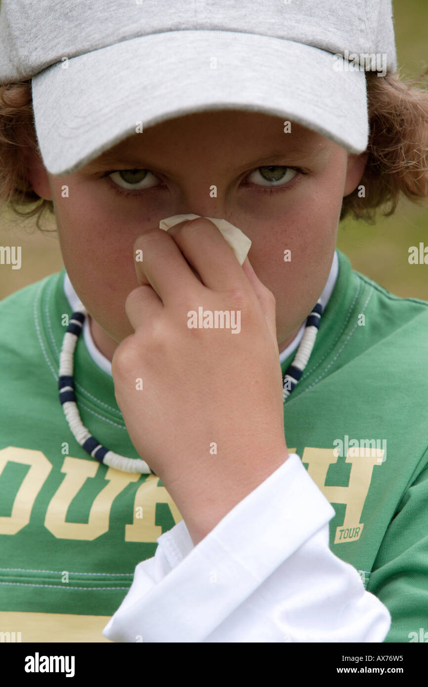 Portrait of a boy blowing his nose Stock Photo - Alamy