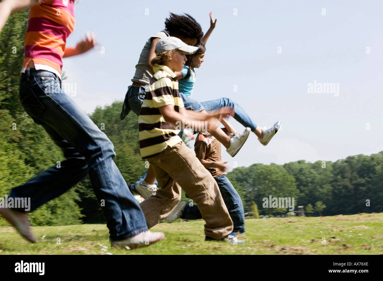 Side profile of five children running in a park Stock Photo - Alamy