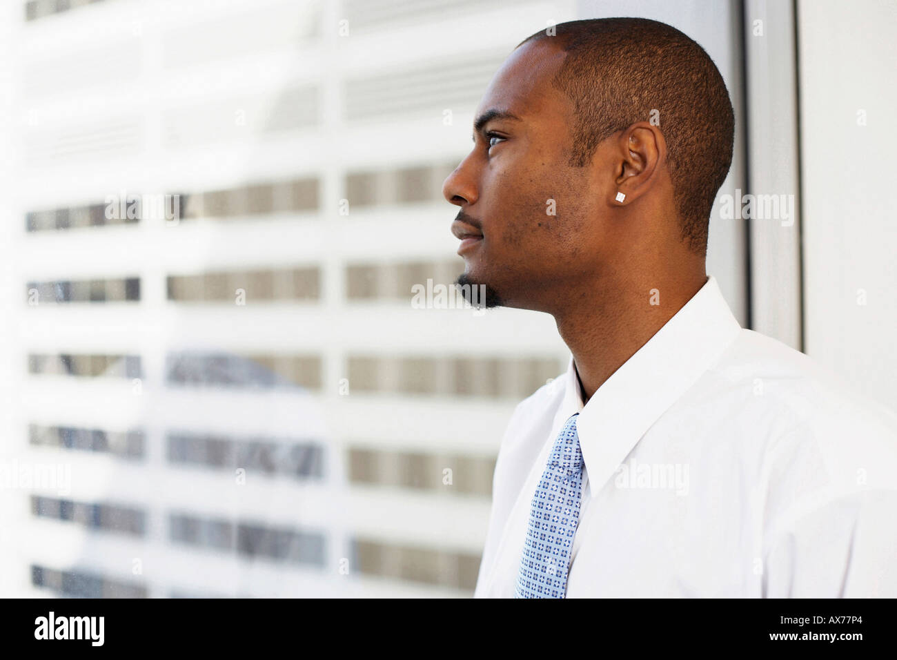 Side profile of a businessman looking through a window Stock Photo - Alamy