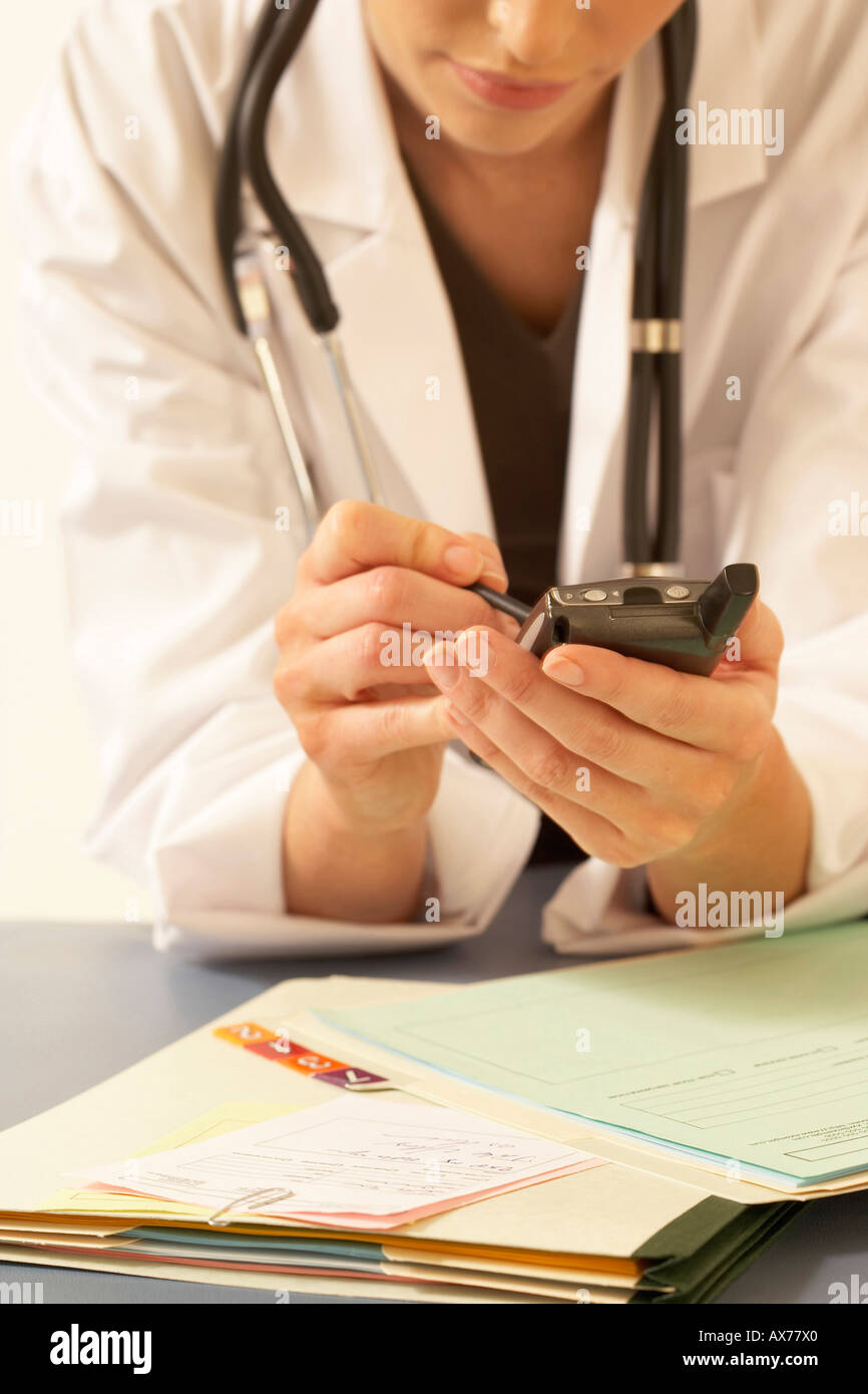 Close-up of a female doctor using a PDA Stock Photo - Alamy