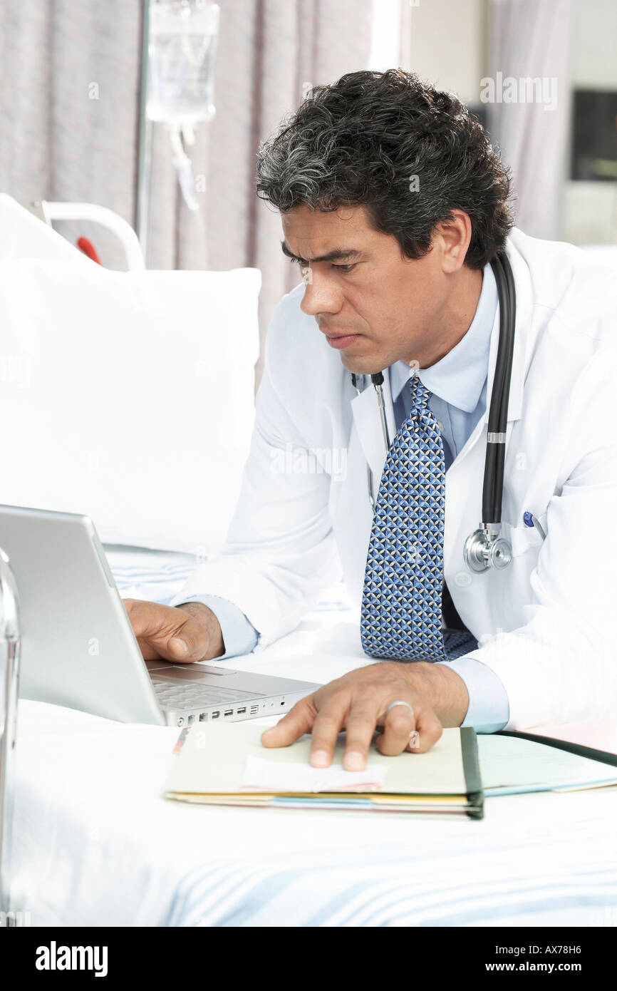 Side profile of a male doctor using a laptop Stock Photo - Alamy
