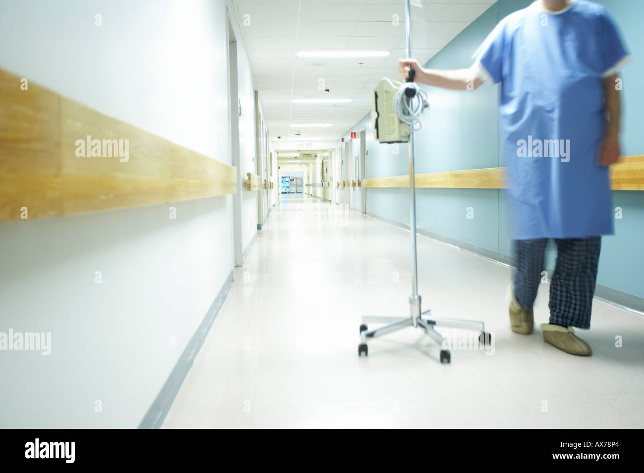 Low section view of a male patient walking with an IV drip stand Stock ...