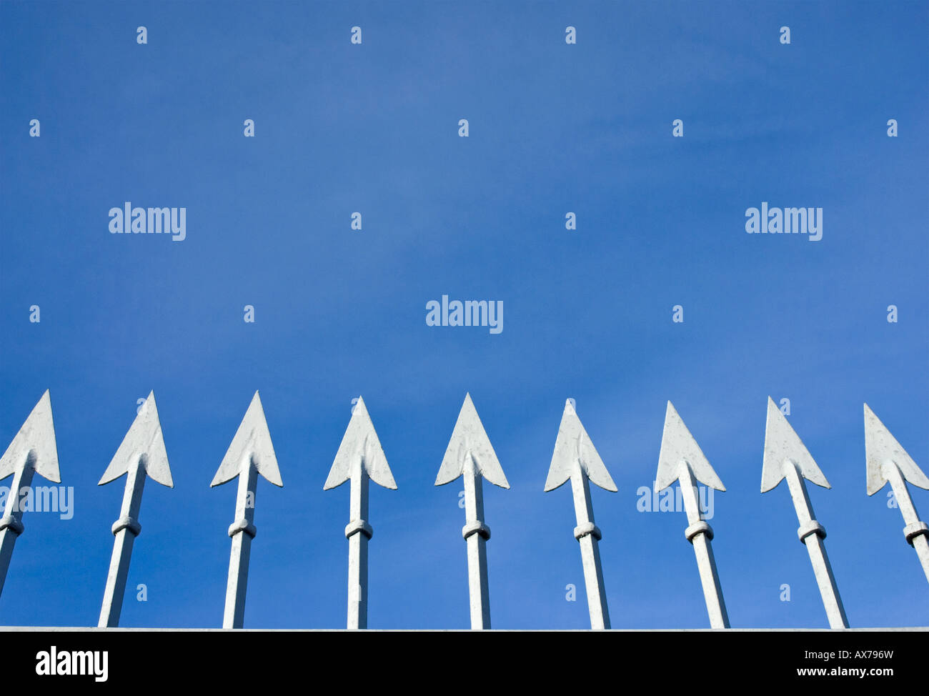 sharp metal fence against blue sky Stock Photo - Alamy