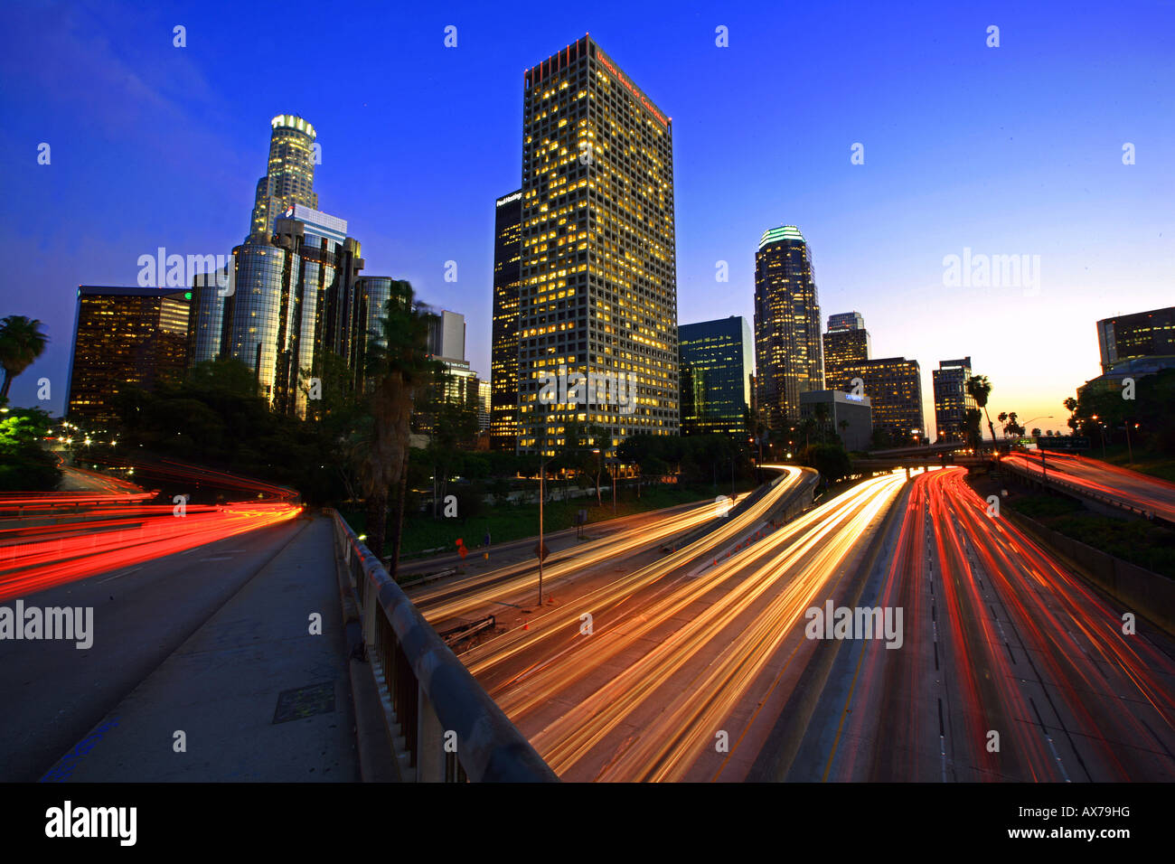 Traffic streaks by the Los Angeles skyline on the 110 Harbor Freeway ...