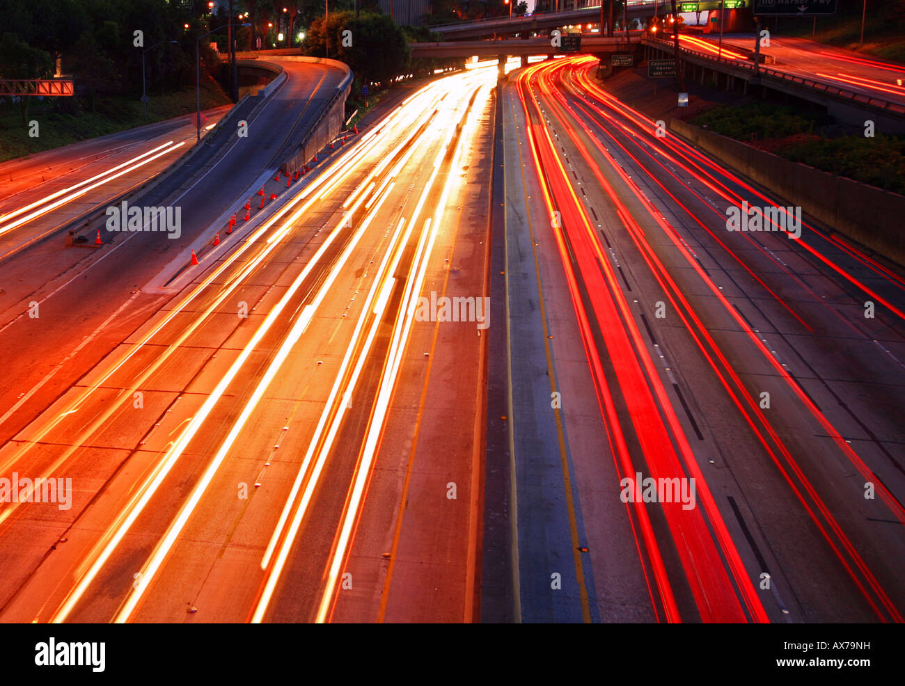 Traffic streaks by the Los Angeles skyline on the 110 Harbor Freeway ...