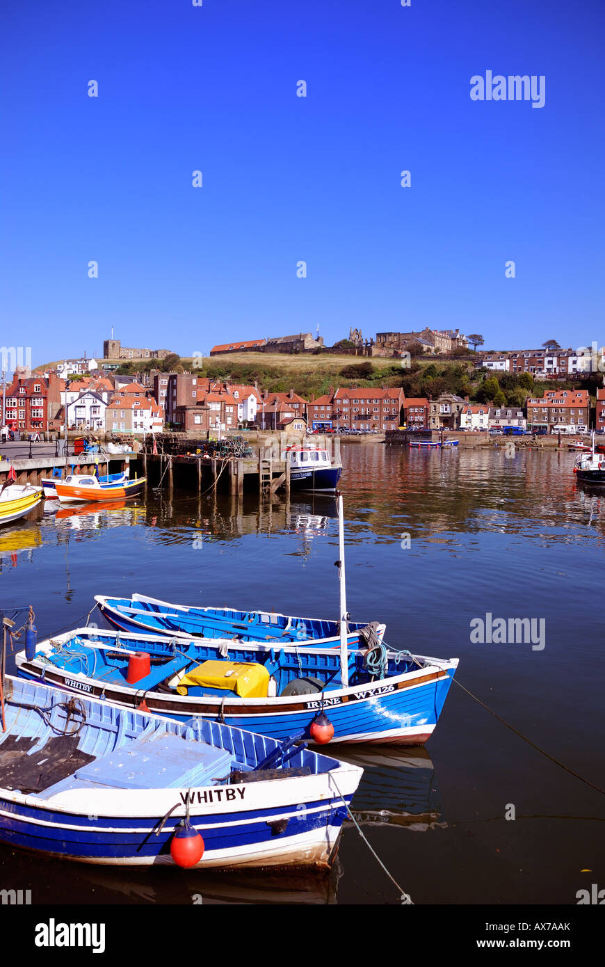 Fishing boats in Whitby Harbour on a summers day with Whitby Abbey in ...