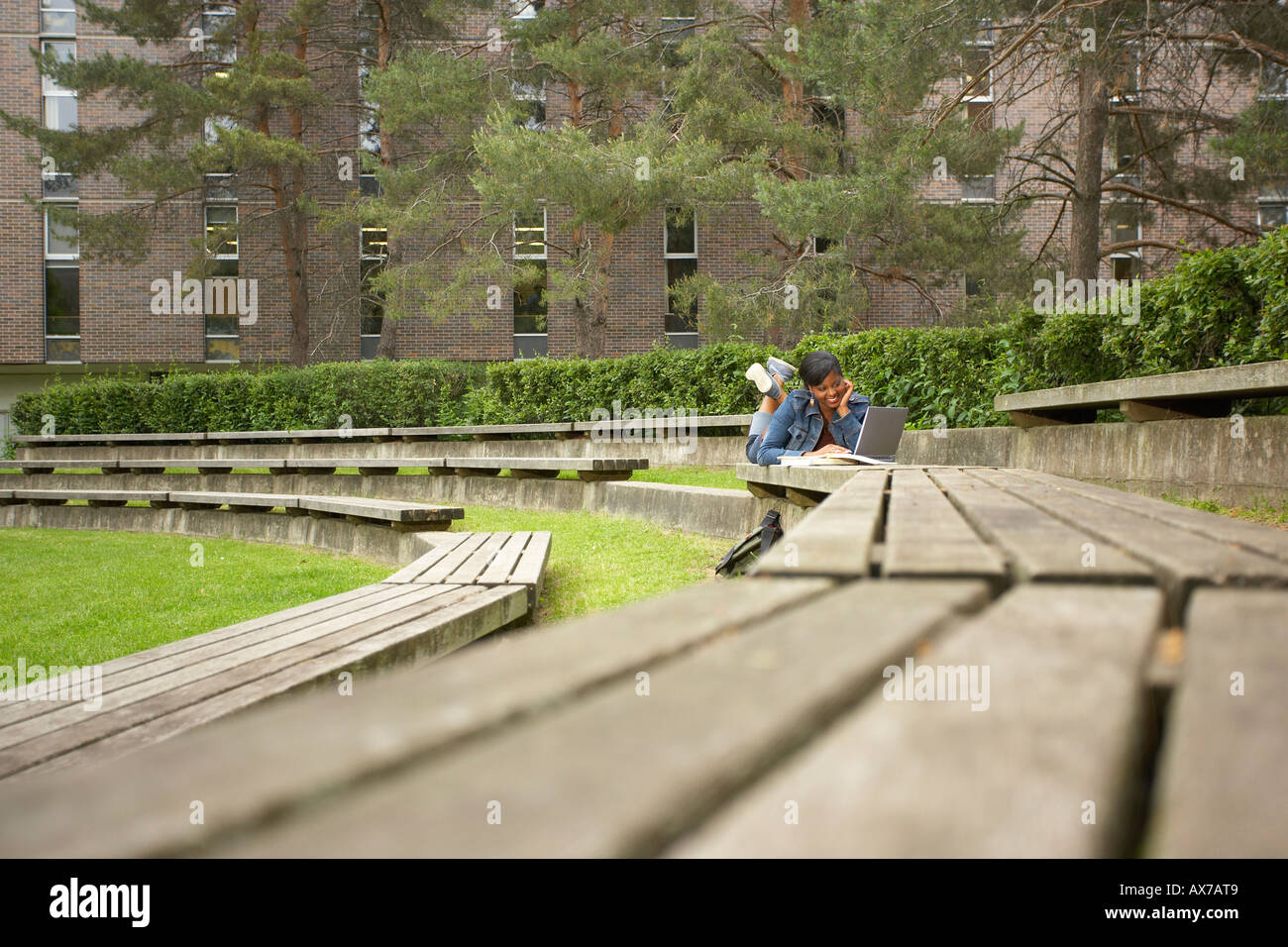 Young woman lying on bench using hi-res stock photography and images ...