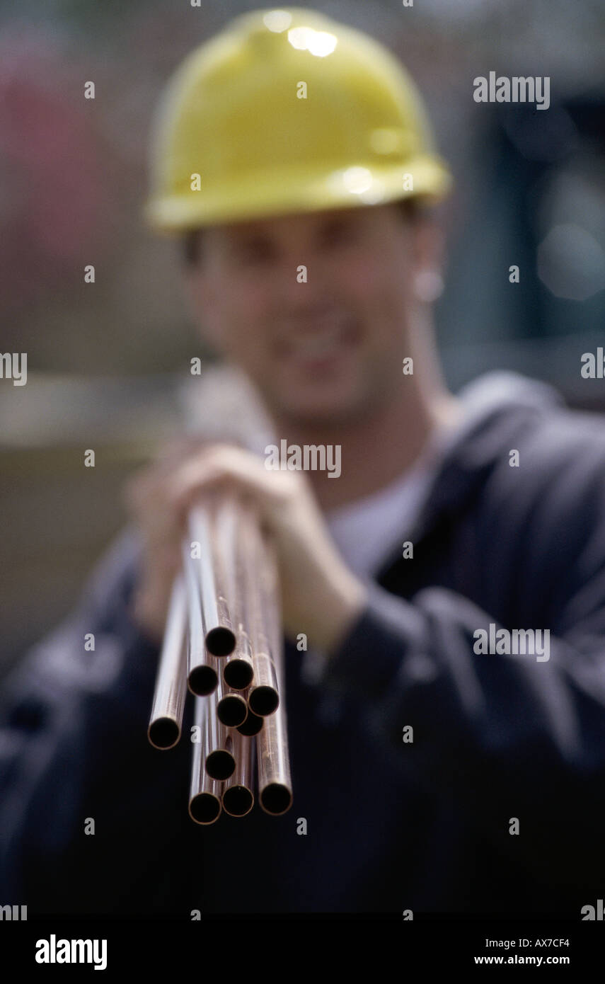 Construction worker carrying pipes hi-res stock photography and images ...