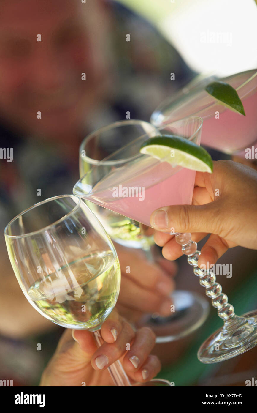 Close-up of three people's hands toasting with glasses Stock Photo - Alamy