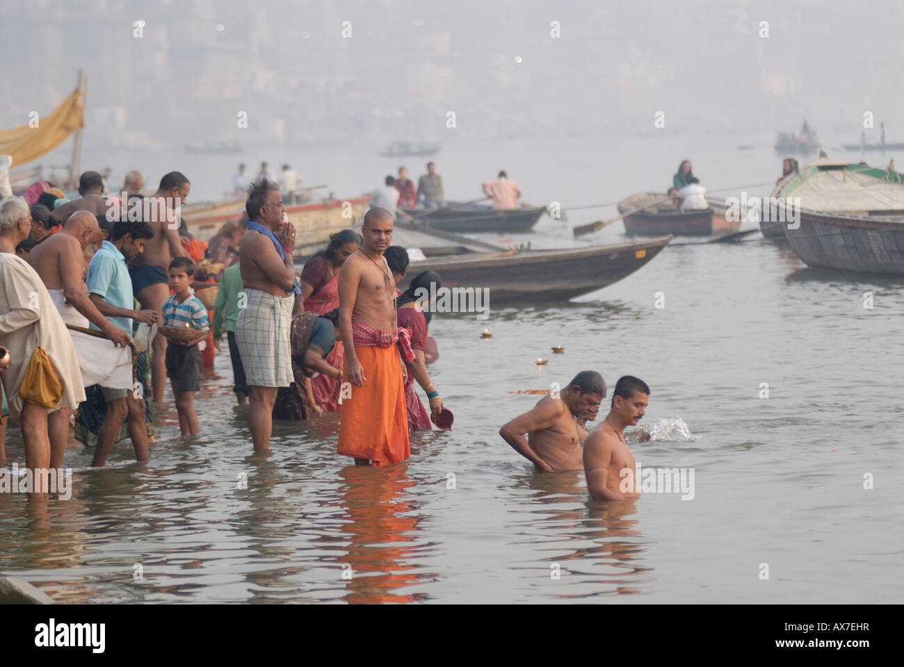 At dawn Hindu's bathe in the Holy River Ganges at Kedar Ghat Varanasi ...