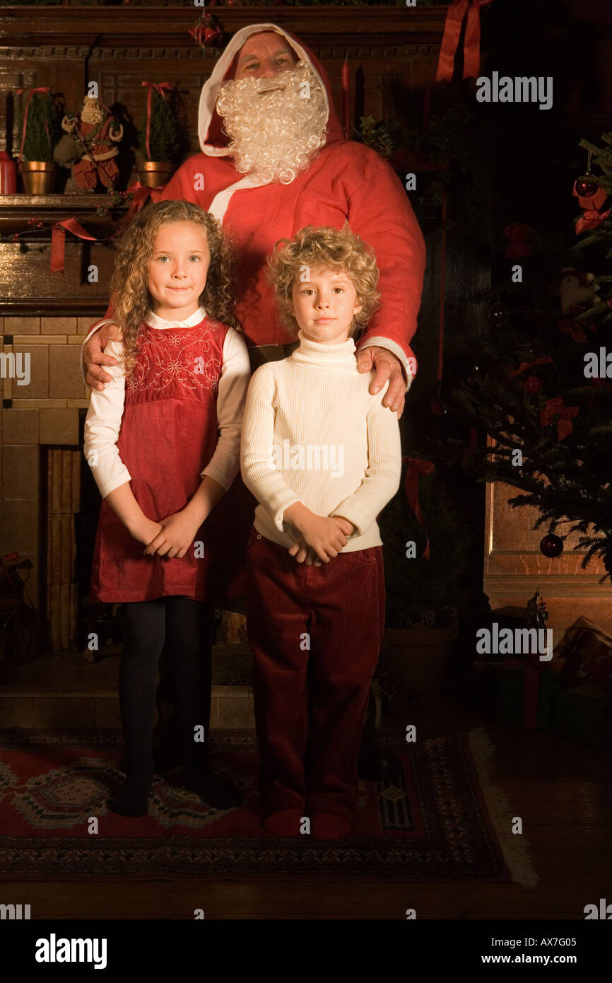 Santa claus with two children Stock Photo - Alamy