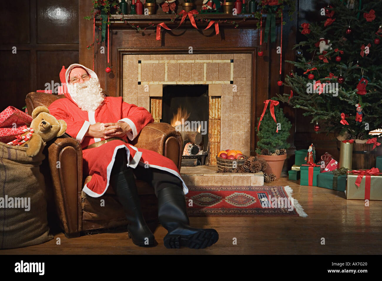 Santa claus resting in an armchair Stock Photo - Alamy