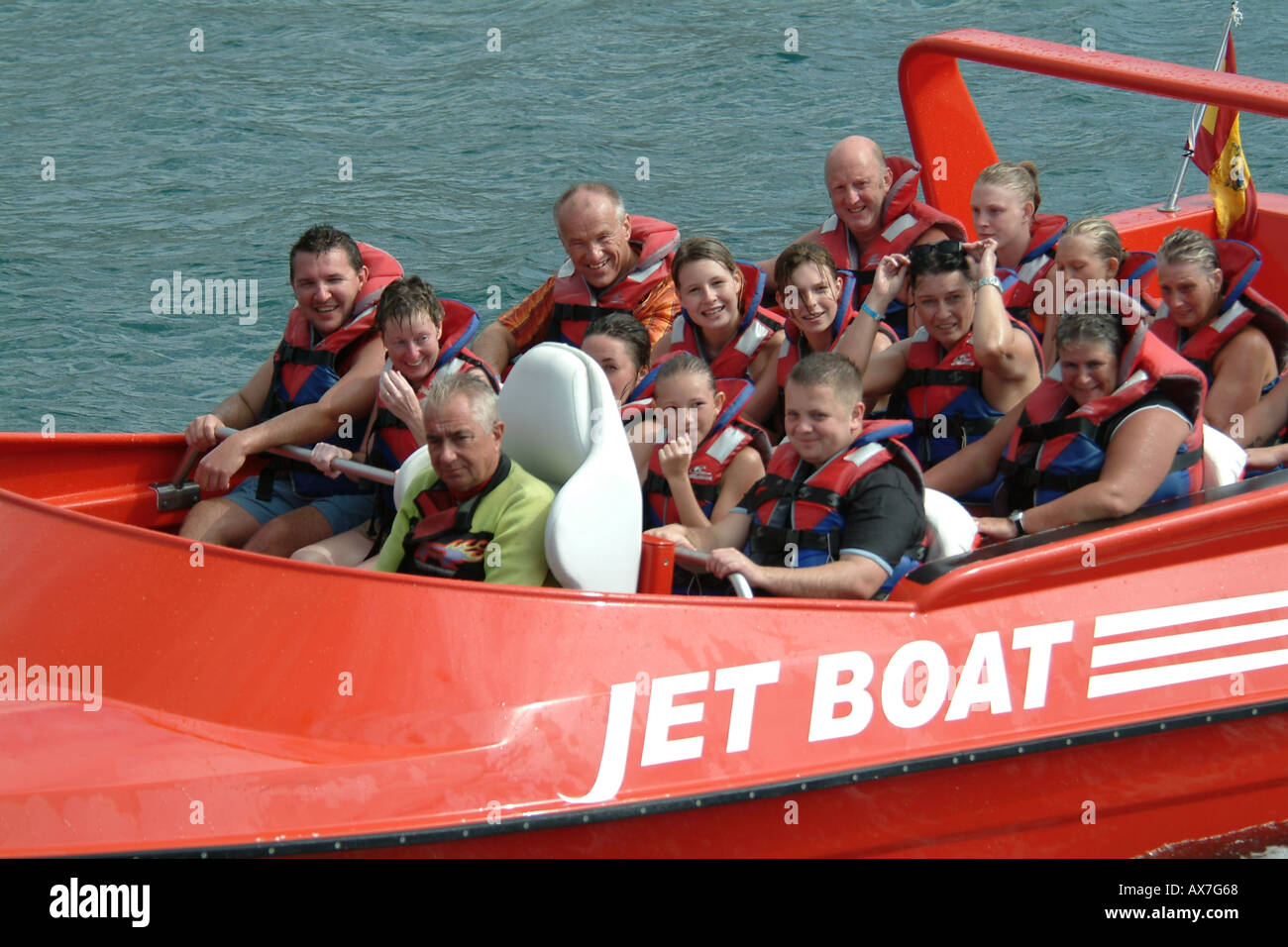 Jet Boat, Big Red with thrill seeking passengers wearing lifejackets ...