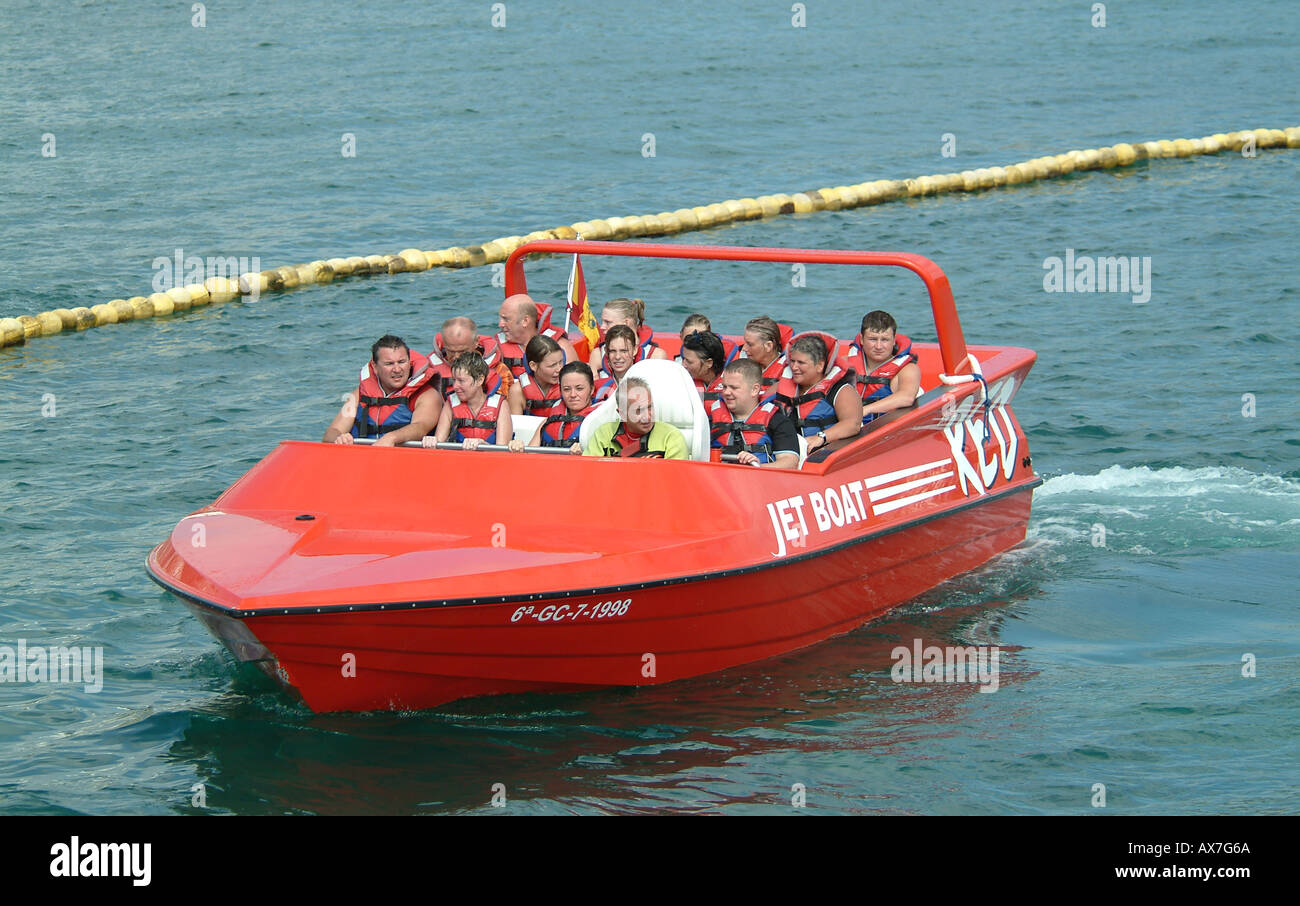 Jet Boat, Big Red with thrill seeking passengers wearing lifejackets ...