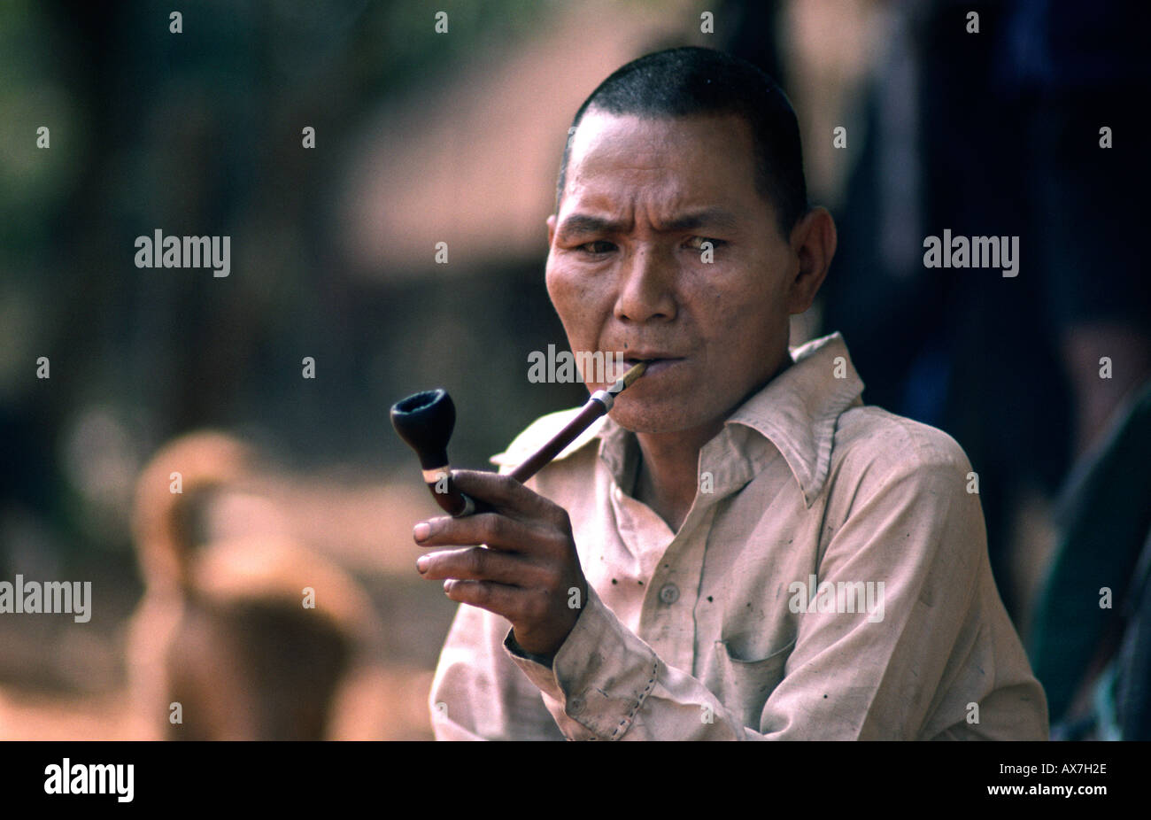 Tribal akha man smoking his pipe hi-res stock photography and images ...