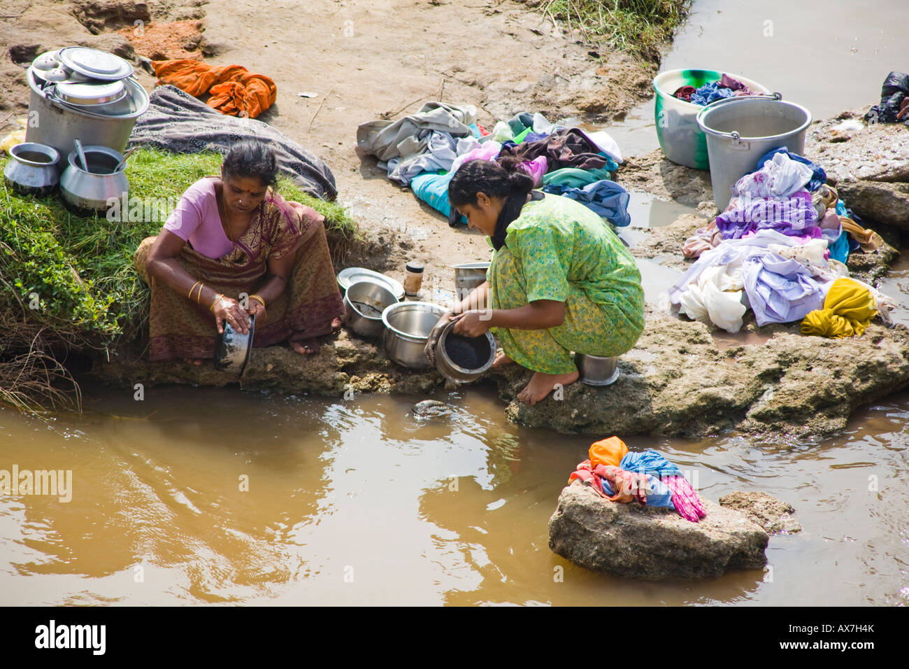 Women washing cooking utensils in a river, Tamil Nadu, India Stock ...