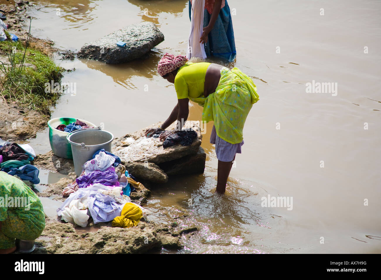 Indian woman washing clothes outside hi-res stock photography and ...