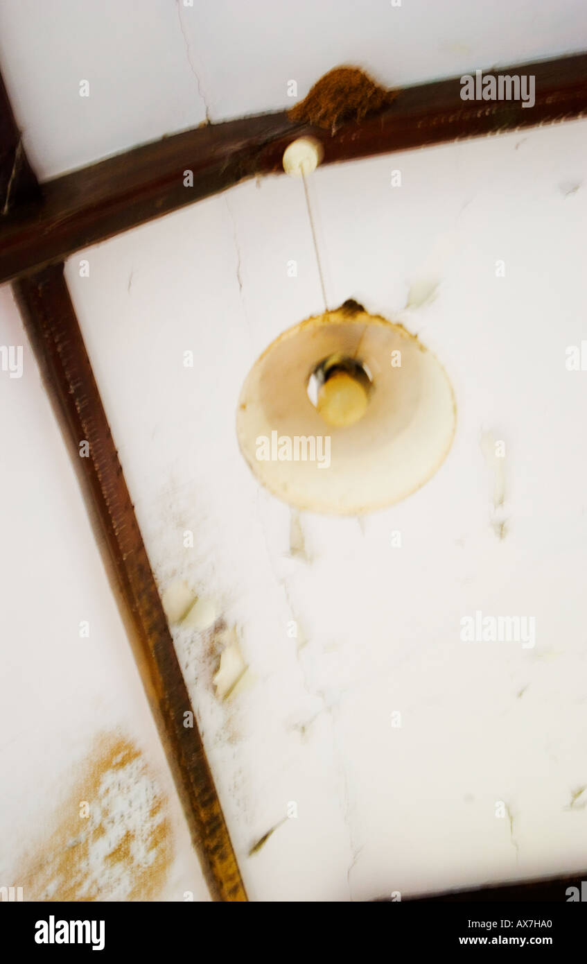 Old light fitting hanging from ceiling Stock Photo - Alamy