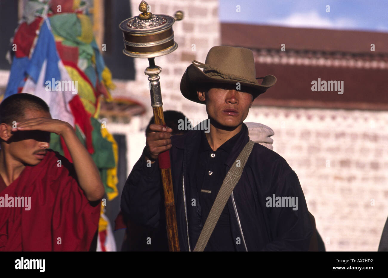 Pilgrim with prayer wheel. Barkhor street, Lhasa, Tibet Stock Photo - Alamy