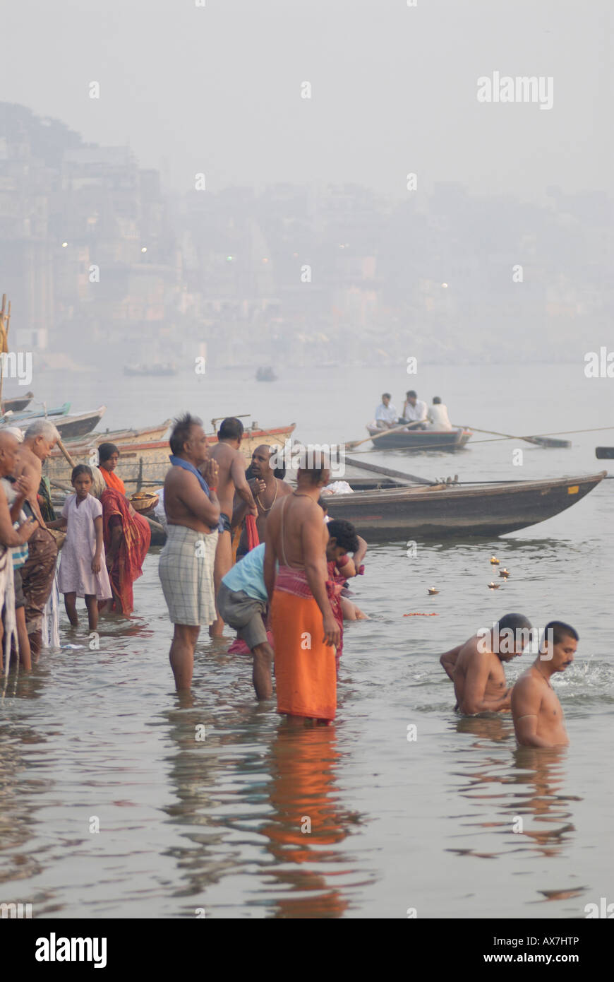 At dawn Hindu's bathe in the Holy River Ganges at Kedar Ghat Varanasi ...