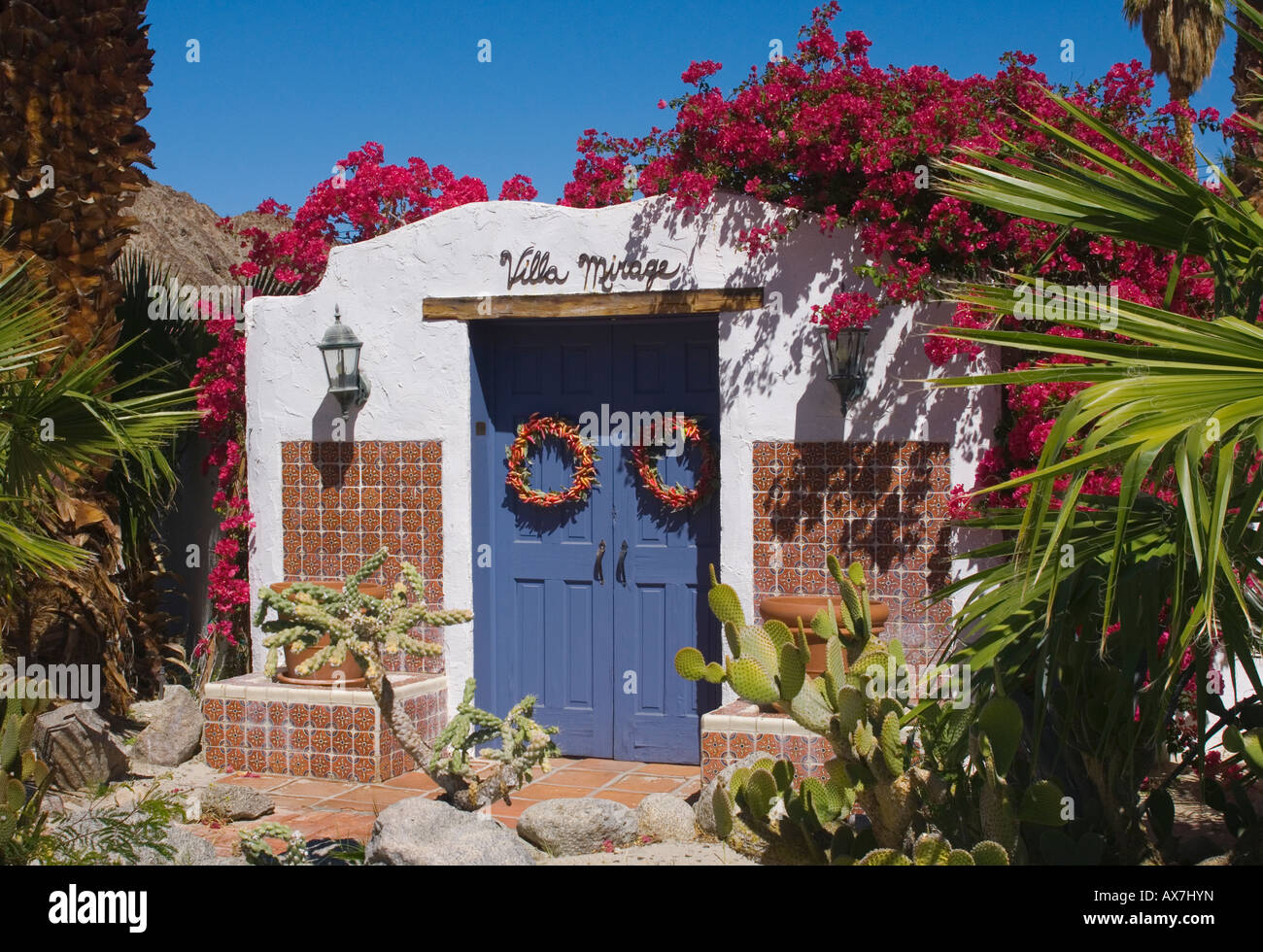 blue entry doors of spanish villa with bougainvilla Stock Photo - Alamy