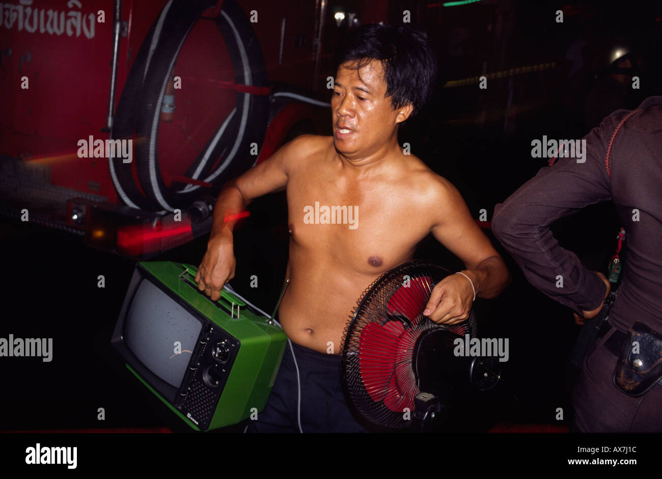 Man escaping fire with his most prized possessions: a TV and a fan ...