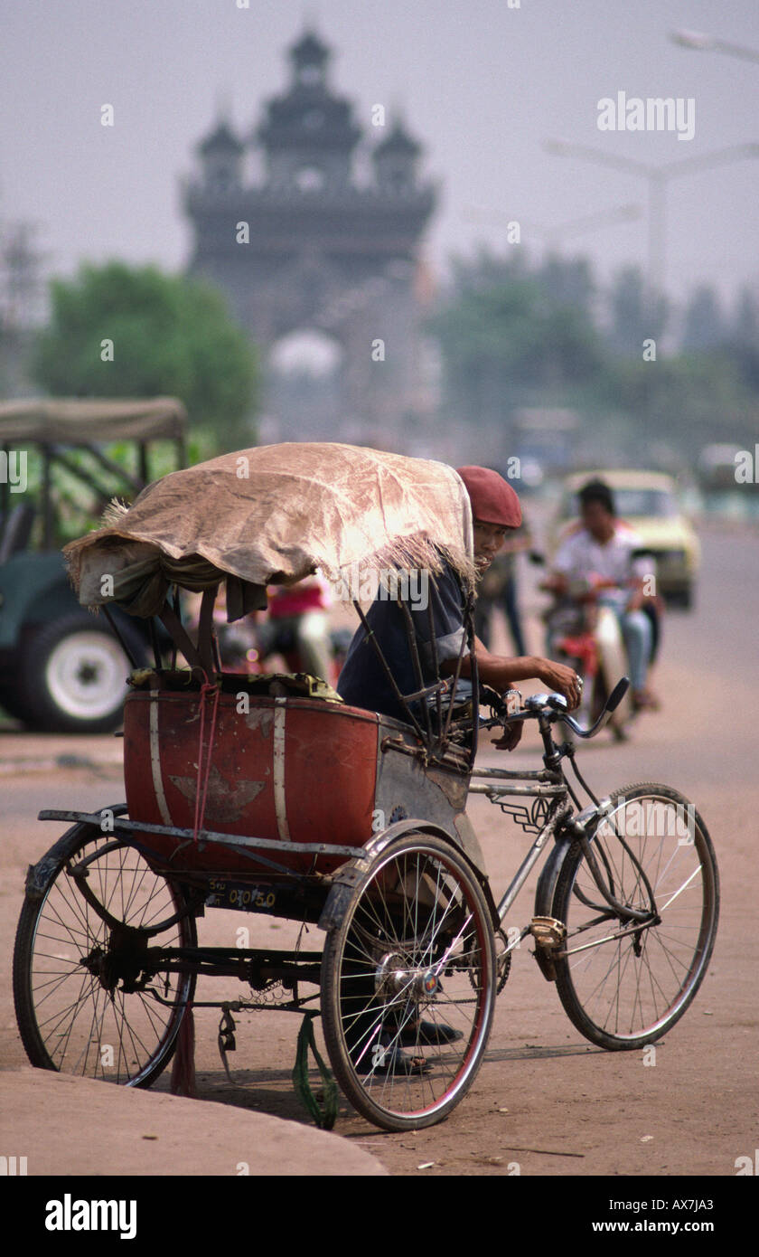 Cyclo driver in front of Patuxay monument. Vientiane, Laos Stock Photo ...
