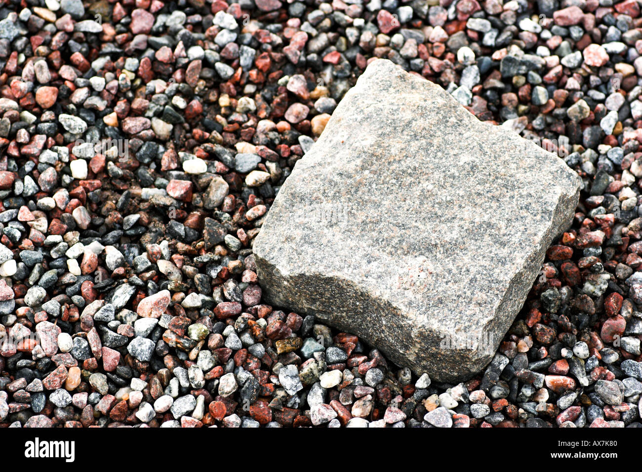 Granite block on pebbles Stock Photo - Alamy