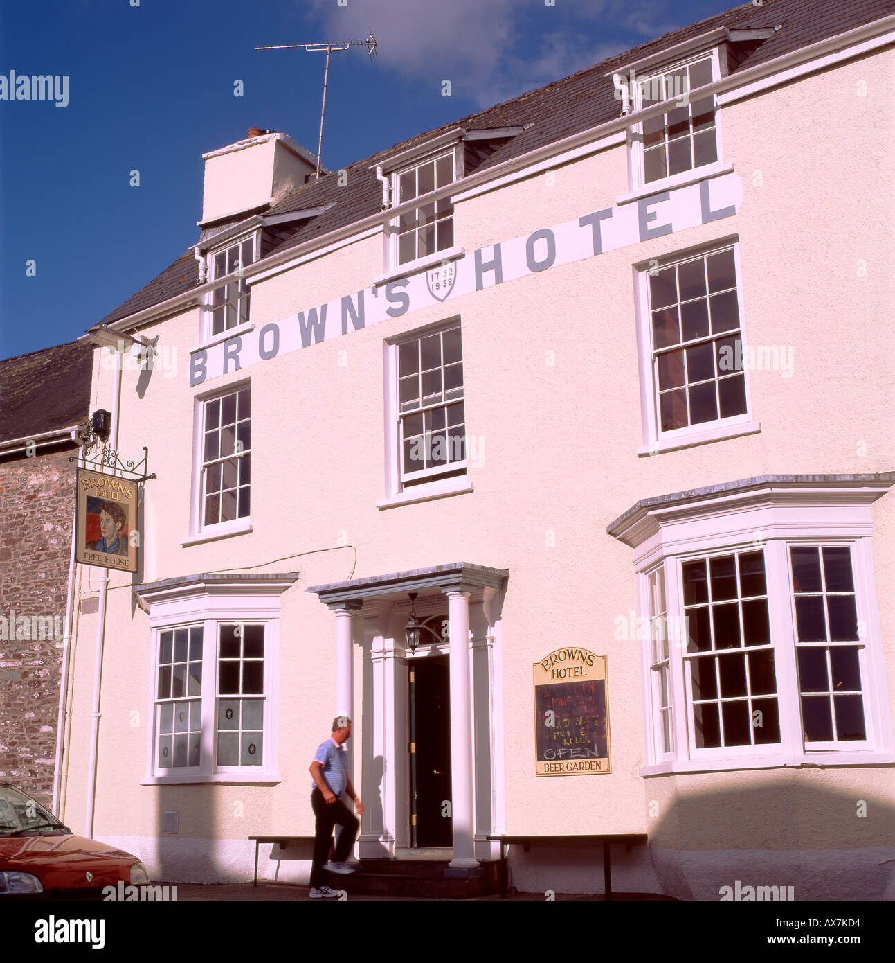Exterior outside view of man walking into entrance of Browns Hotel pub ...