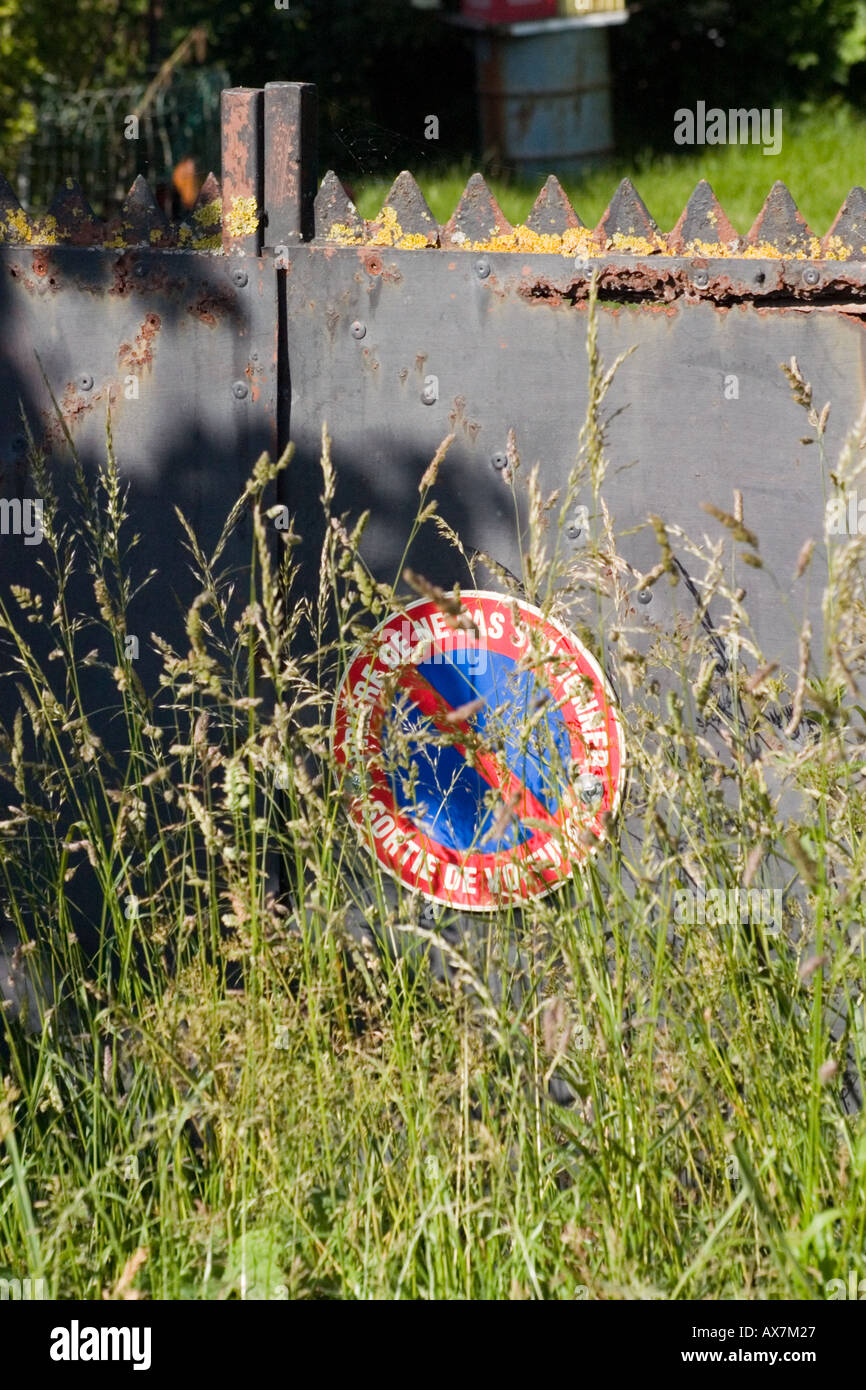 Corroded gate with no parking sign stating access is required 24 7 but ...