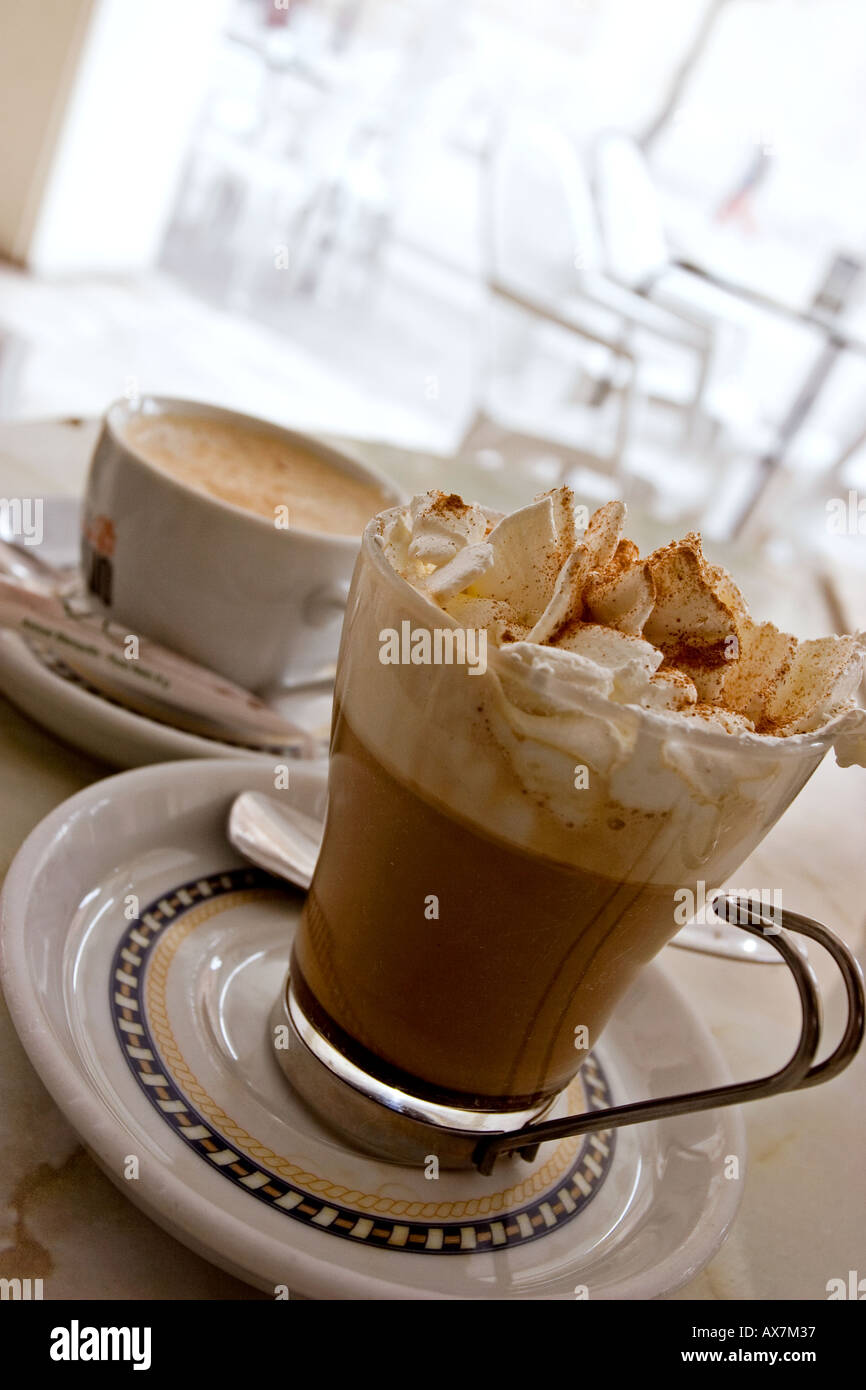 Spanish style Cappuccino with a cafe con leche behind Stock Photo - Alamy