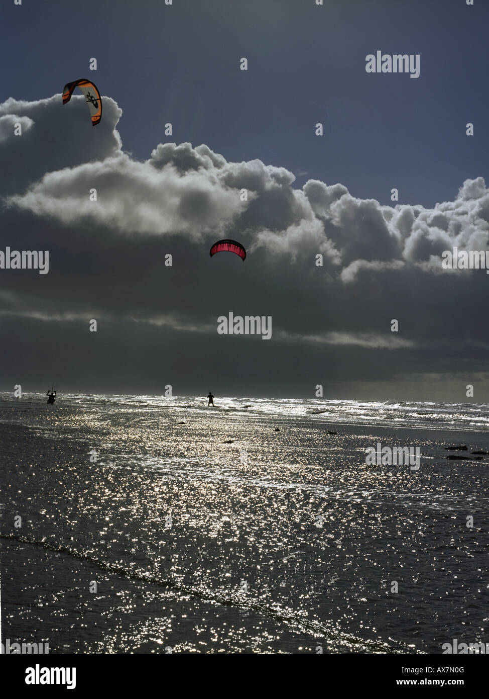 Kite Surfers, surfing the waves in the afternoon sun. At Lytham St ...