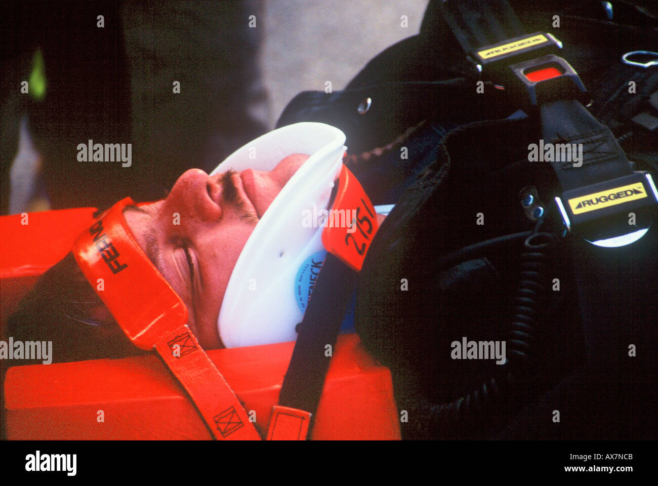 An injured man on the stretcher being taken in the ambulance to the ...