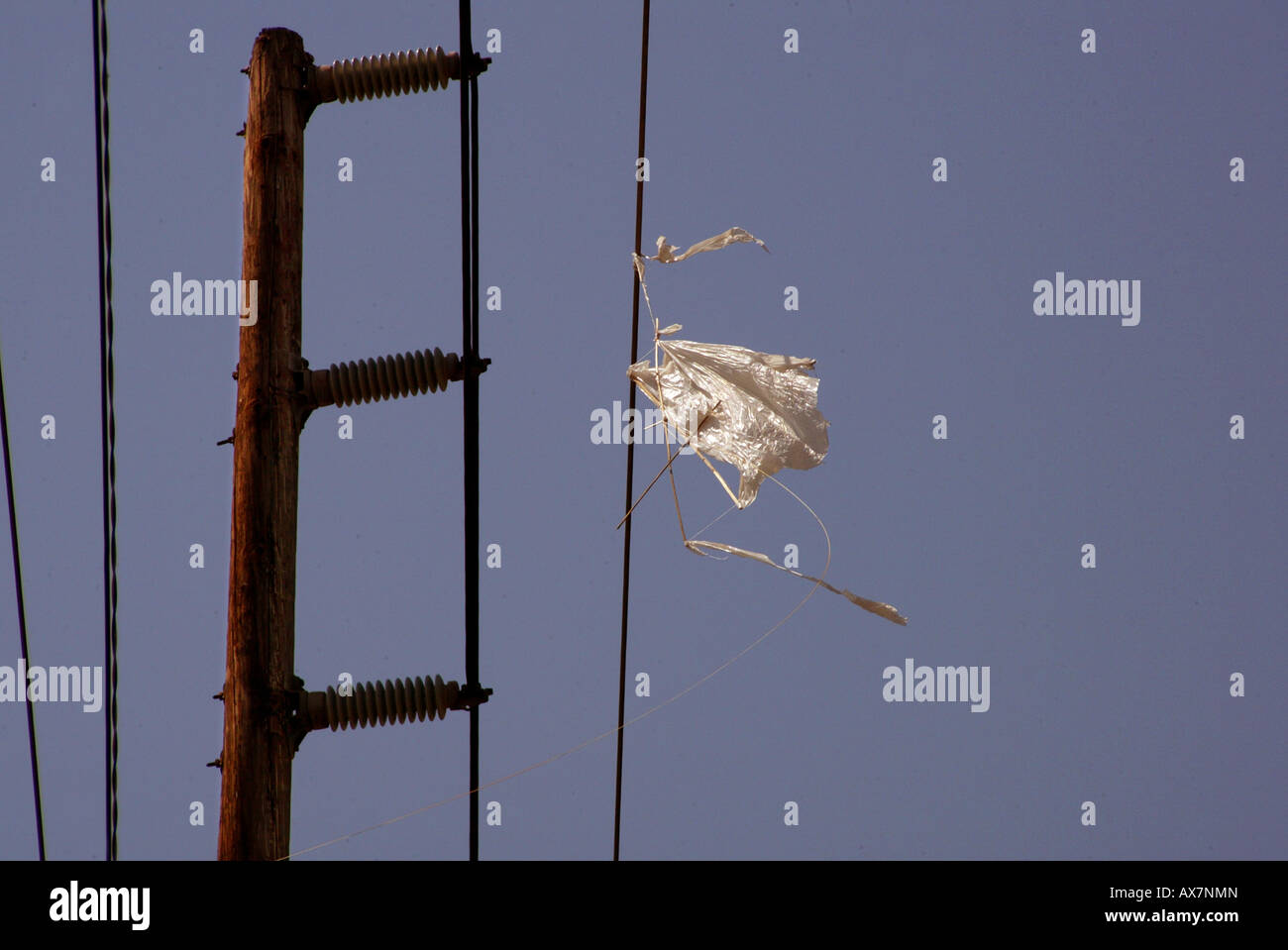 Runaway kite is stuck on high power electrical lines creating potential ...