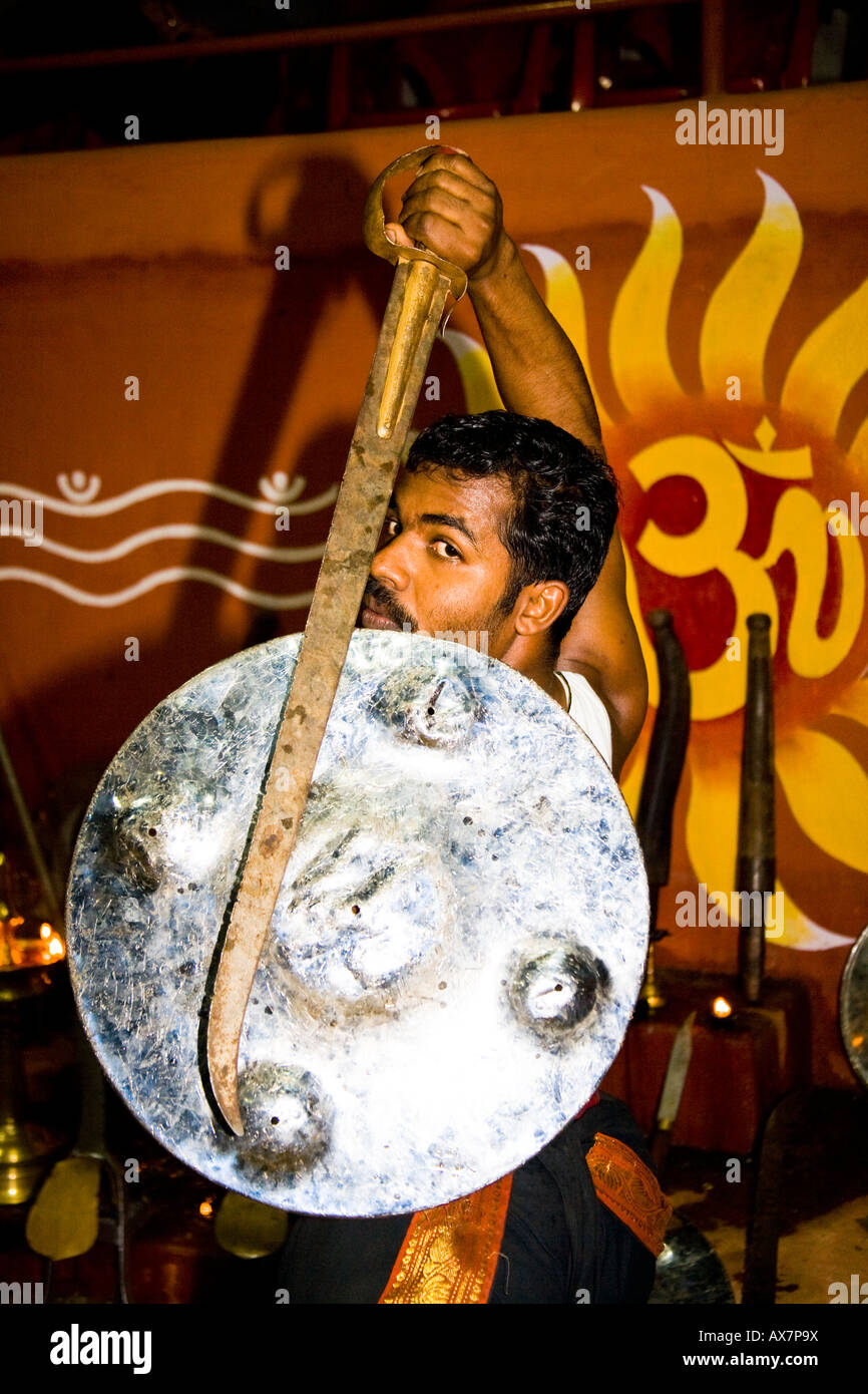 Kalarippayattu martial arts performer posing with sword and shield ...