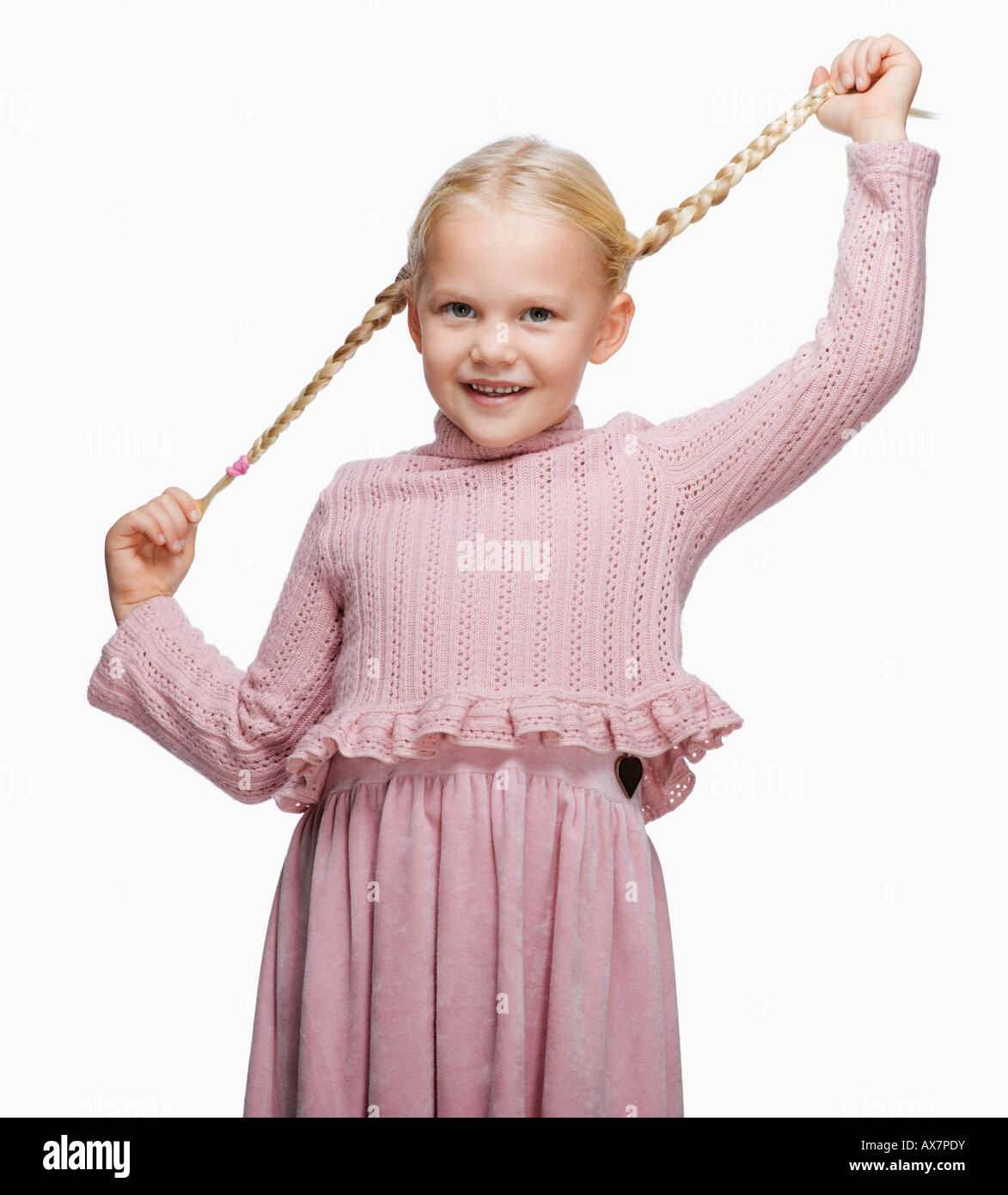 Blond girl (6-8) in a dress, fooling about, portrait Stock Photo - Alamy