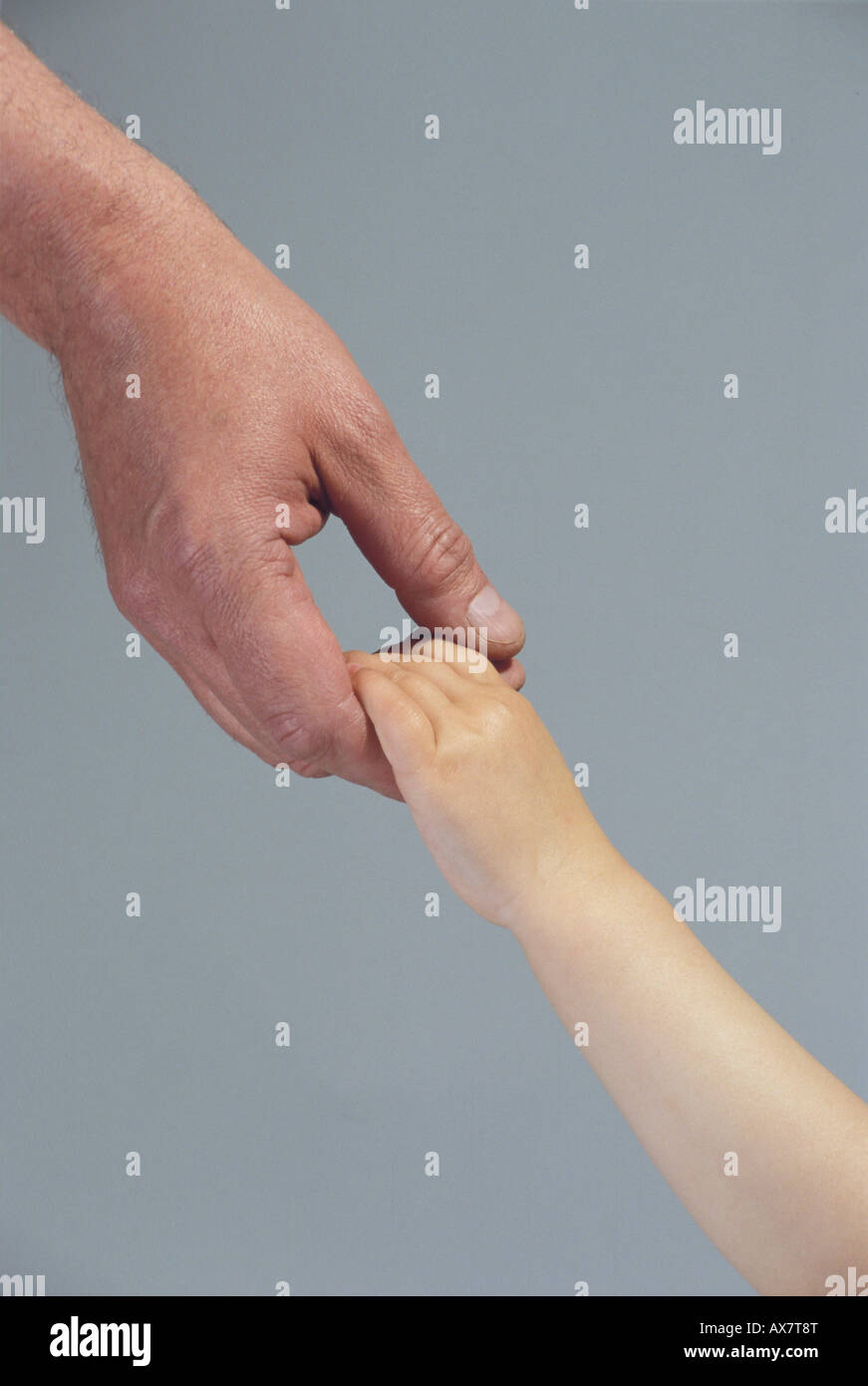 Hand of an adult holds child hand Stock Photo - Alamy