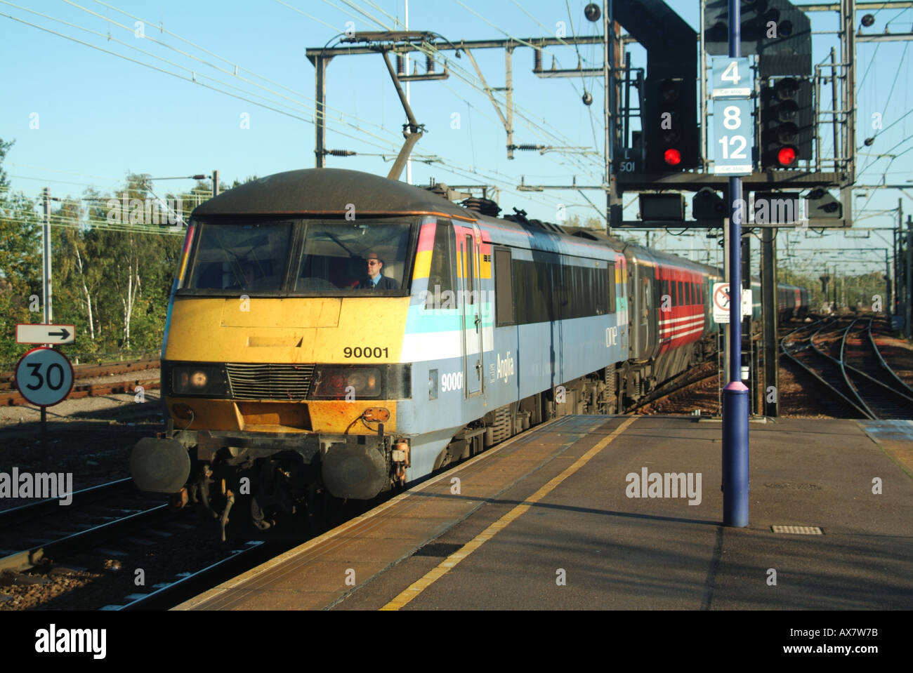 Essex One Anglia railway company train arriving at station platform ...