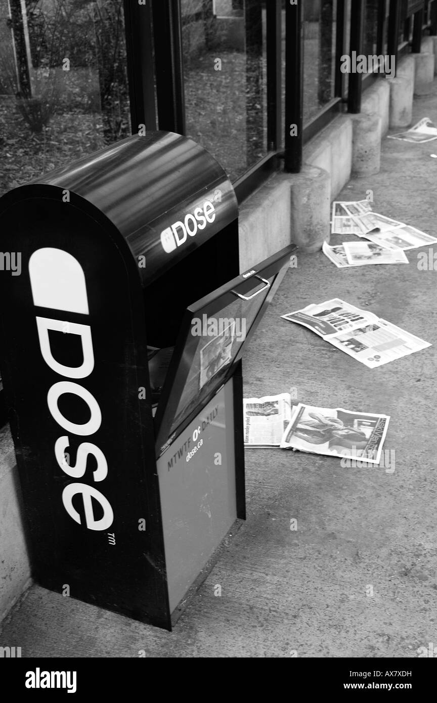 A trail of newspapers lead to an open Dose newspaper box Stock Photo ...