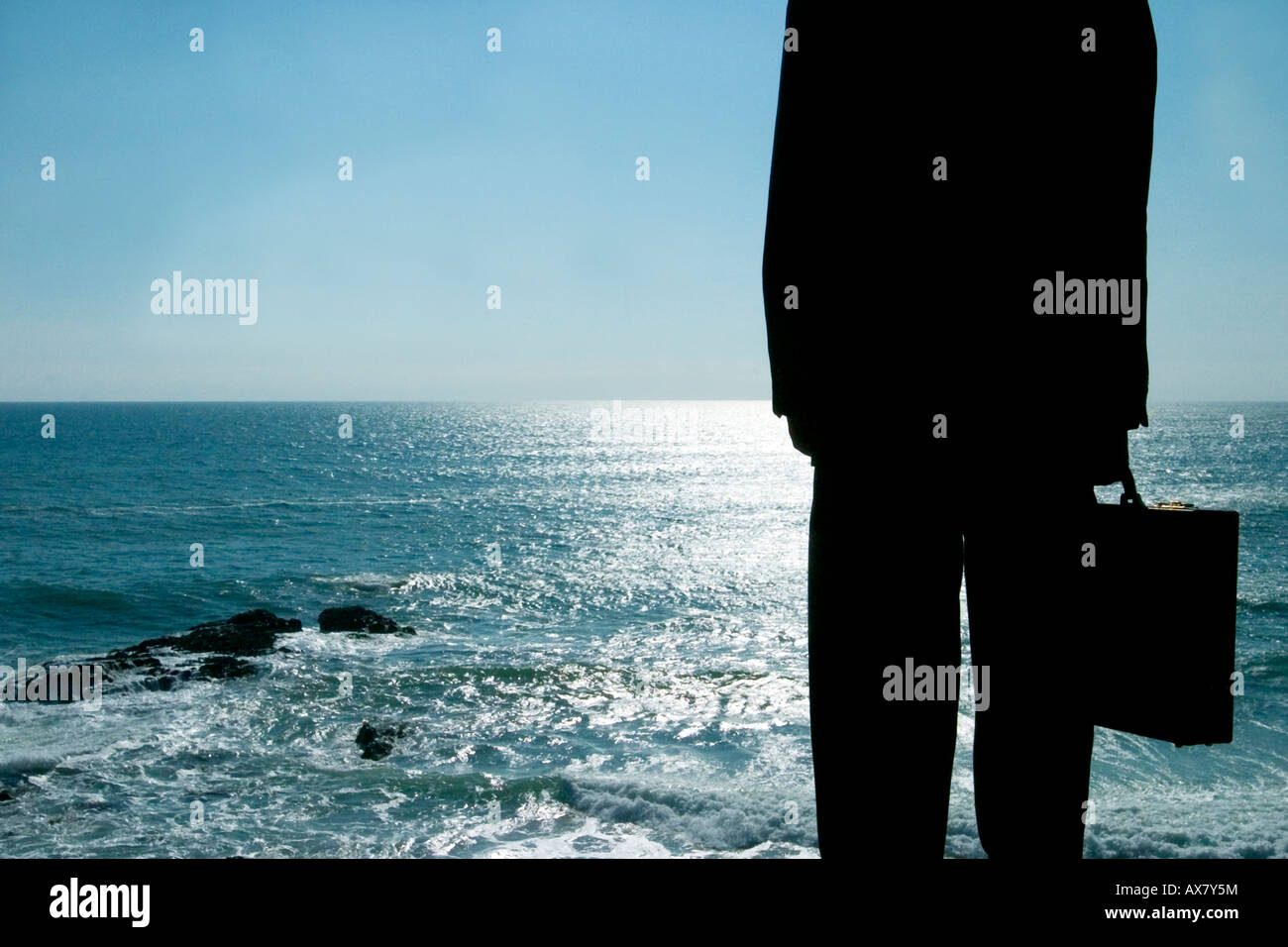 Business man stares out into the ocean Stock Photo - Alamy