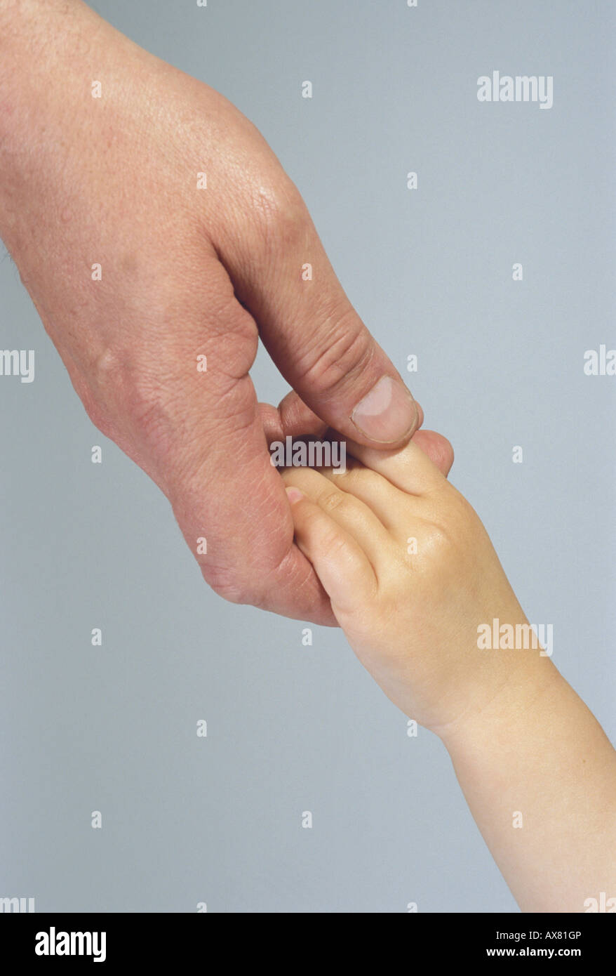 Hand of an adult holds child hand Stock Photo - Alamy